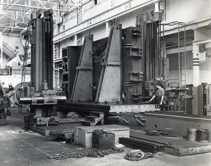 High-quality black-and-white photographs of large old machines and tools