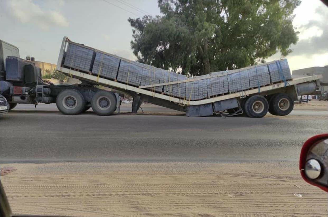 Flatbed trailer bent in half - photo