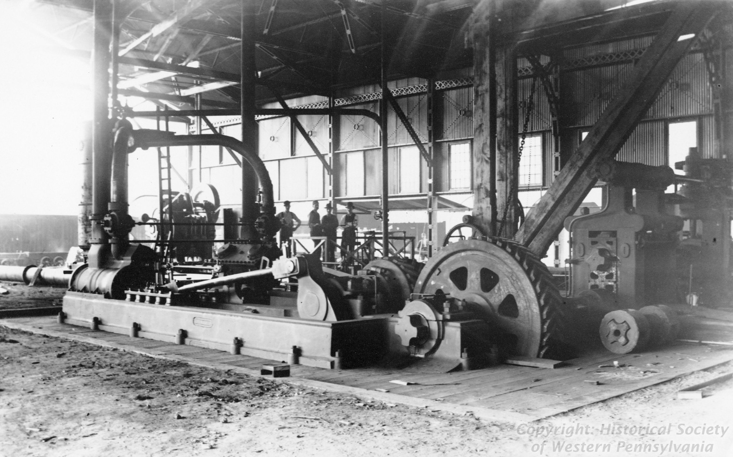 High-quality black-and-white photographs of large old machines and tools